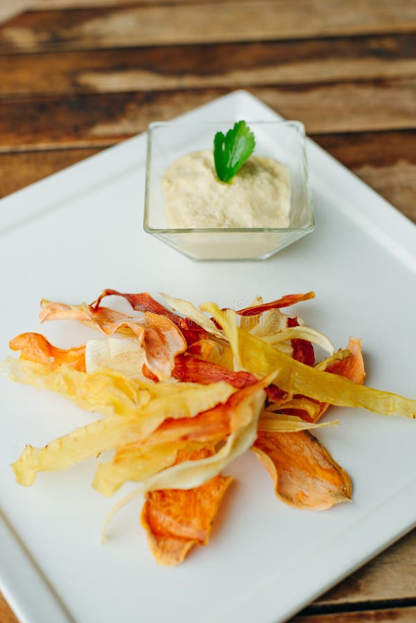 Hummus with Root Vegetable Color Chips in Restaurant Stock Photo ...