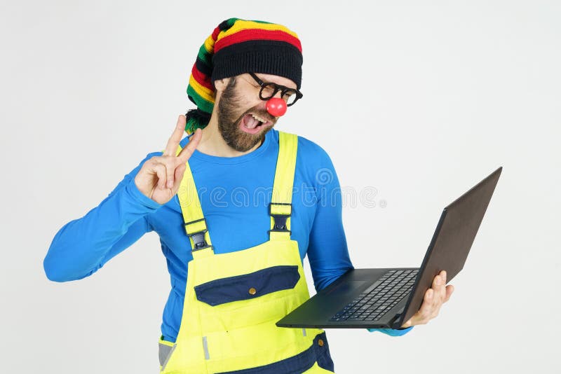 A Clown in a Bright Suit Holds a Computer in His Hands - Communicates ...