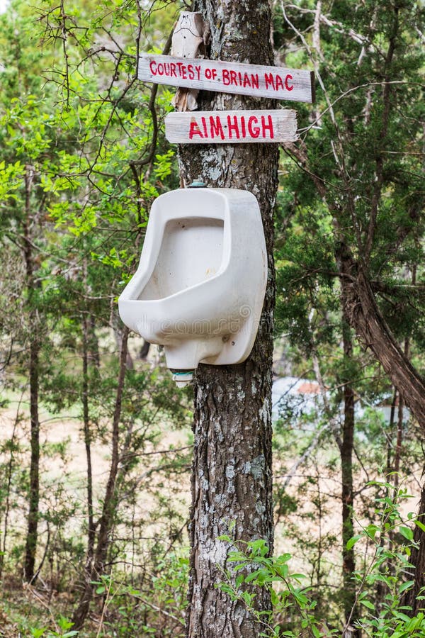 Humorous Sign and Urinal Mounted on a Tree Editorial Photo - Image of ...