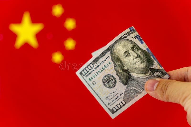 A Hundred Dollar Bill on the Background of the Flag of the China ...