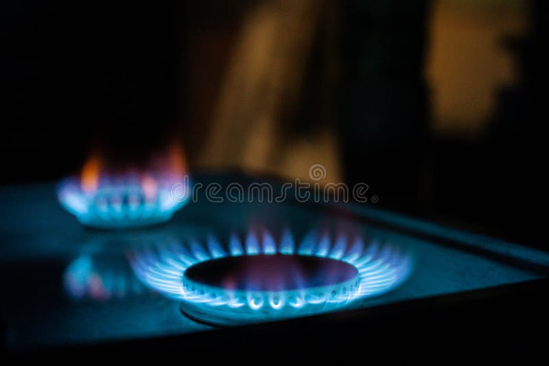 A Hundred Dollar Bill on a Gas Burner with a Burning Fire on a Black ...