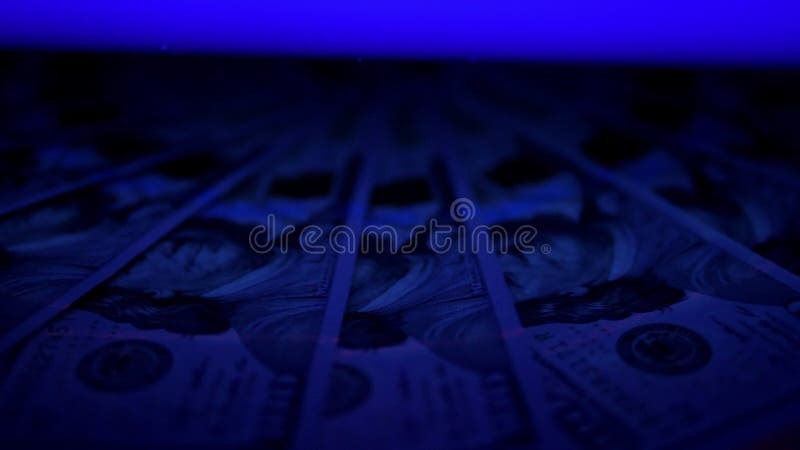 Hundred Dollar Bills Under Ultraviolet Light Slowly Rotates in a Circle ...
