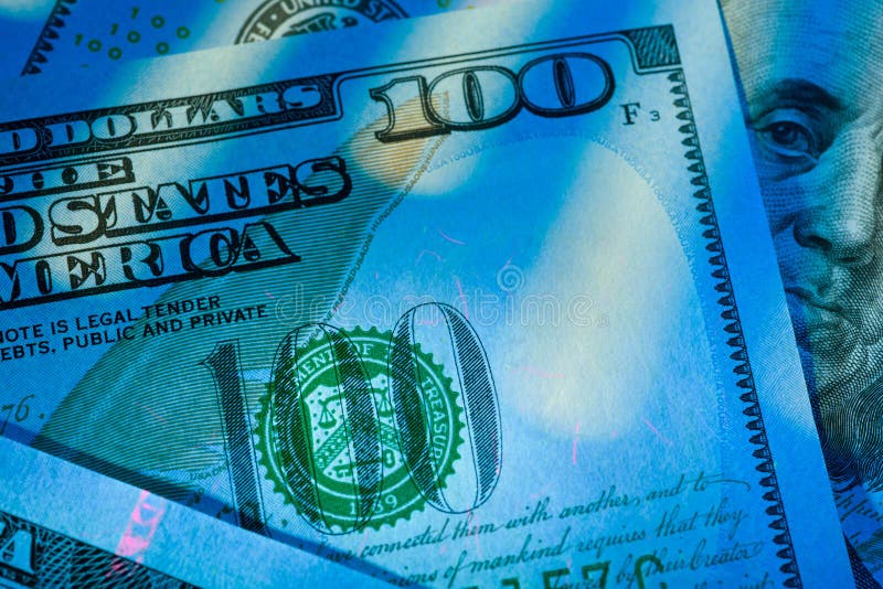 Hundred US Dollar Bills Glow Under Ultraviolet Light. Verifying the ...
