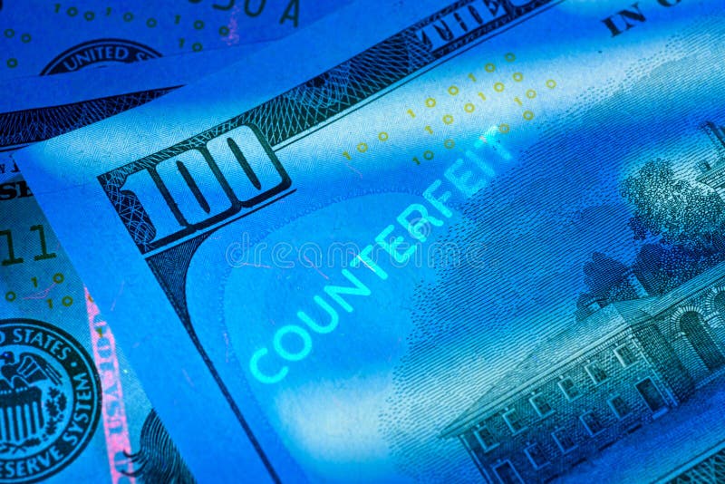 Hundred US Dollar Bills Verifying Under Ultraviolet Light. Counterfeit ...