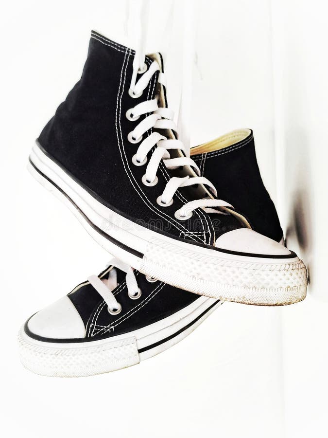 Hunging Crossed Black Converse Shoes on a White Background Stock Image ...