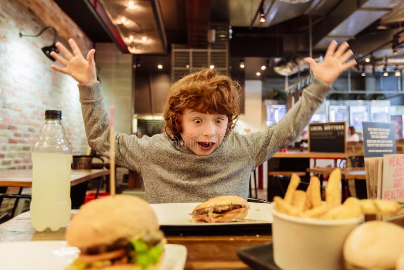 Hungry Boy Eats Burger in Restaurant Stock Image - Image of restaurant ...