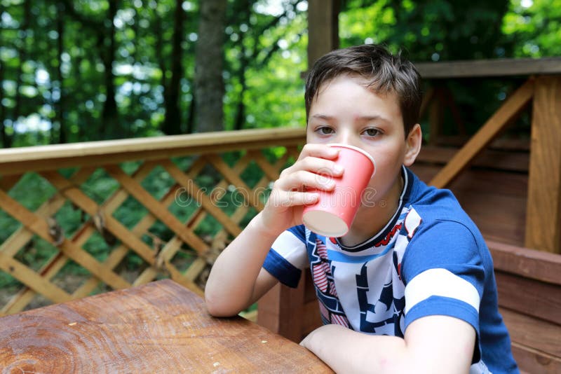 Hungry child drinking tea stock photo. Image of drinking - 254304954