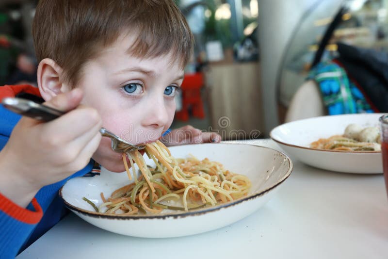 Hungry child eating bread stock image. Image of emotions - 44041255