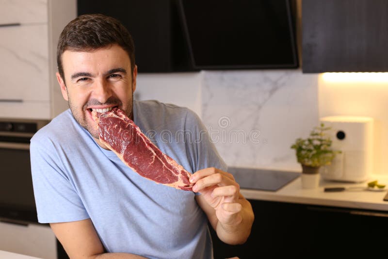 Hungry man eating raw meat stock image. Image of funny - 263996545
