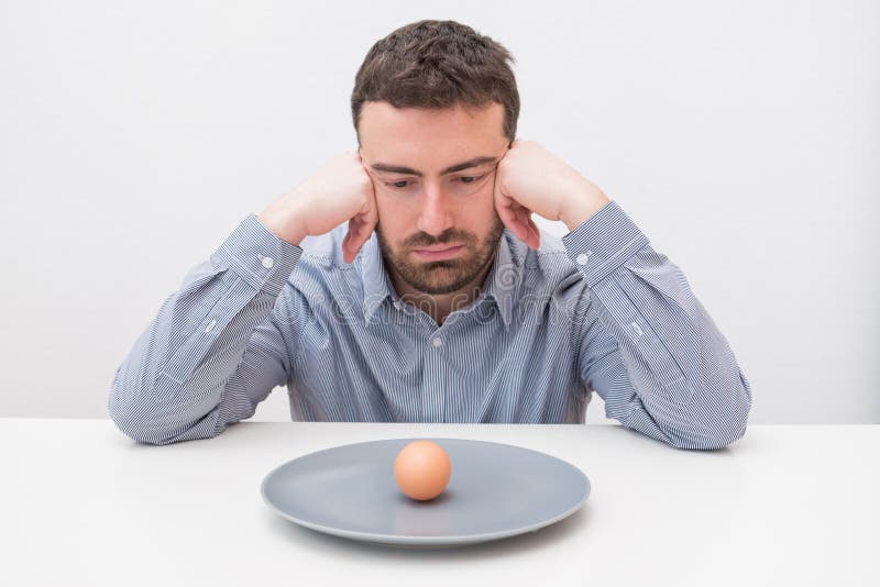 Hungry man feeling sad stock photo. Image of disease - 83157548