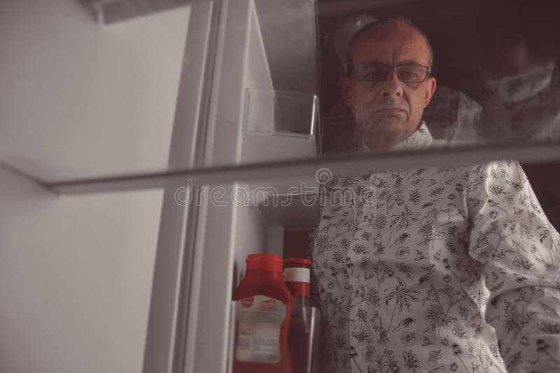 Hungry Man Looking for a Late Night Meal in an Empty Fridge. Senior Man ...