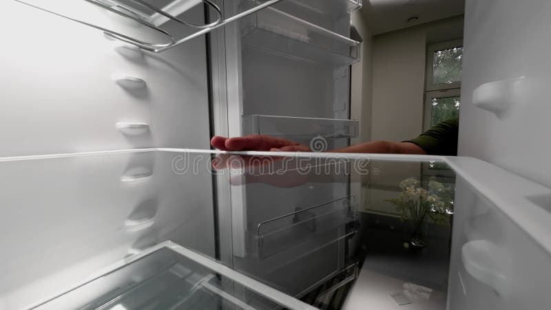 When Hungry, a Man Looks into the Refrigerator and Checks that it is ...