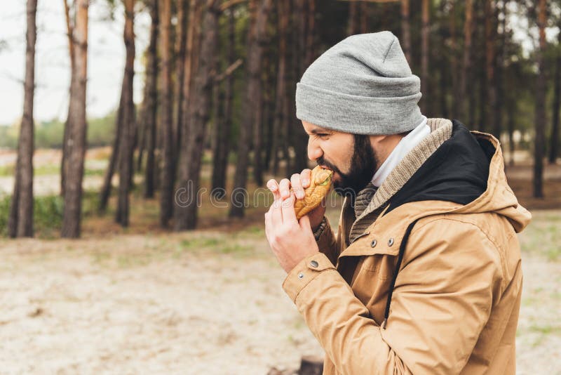 Hungry young man eating stock photo. Image of caucasian - 119771532