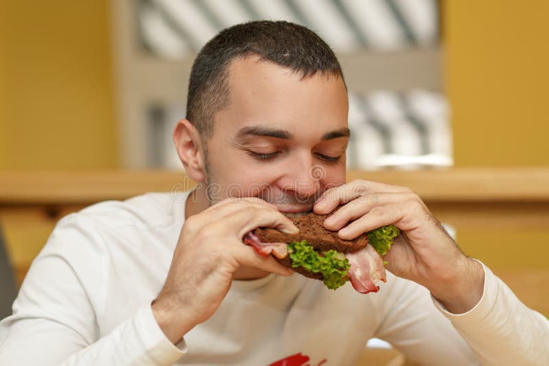 Hungry Young Man in Resaurant Eat Sandwich Stock Image - Image of ...