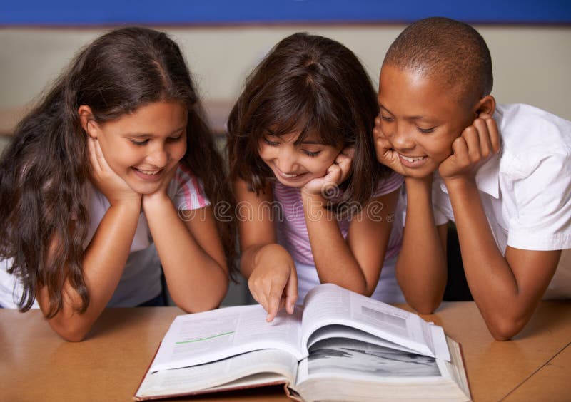 Hungry Young Minds. Three Multi-ethnic Children Reading through a ...