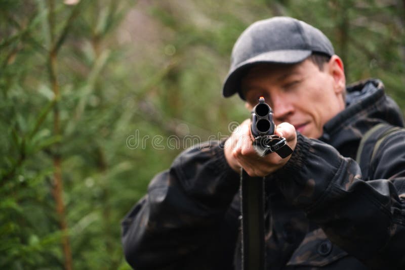 Hunter aiming a shotgun stock photo. Image of rifle - 200747262