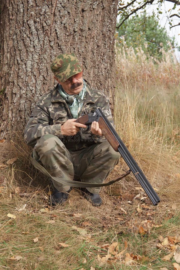 Hunter examines the gun stock photo. Image of hunter, hunting - 3261246