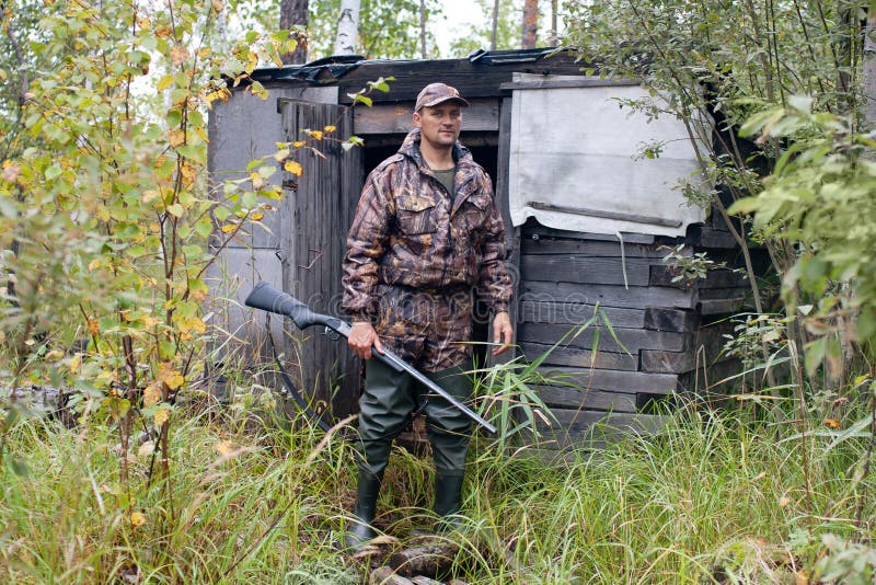 Hunter at the forest hut stock photo. Image of rural - 61653842