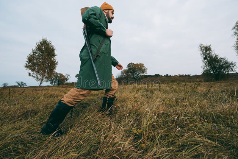 Hunter Going with Gun in Field Stock Photo - Image of weapon, alone ...