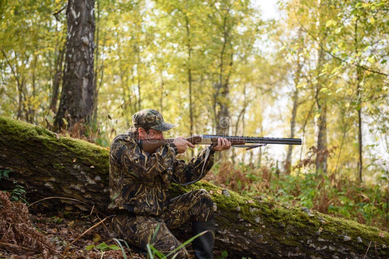Hunter with a Gun in the Autumn Woods Stock Photo - Image of pursuit ...