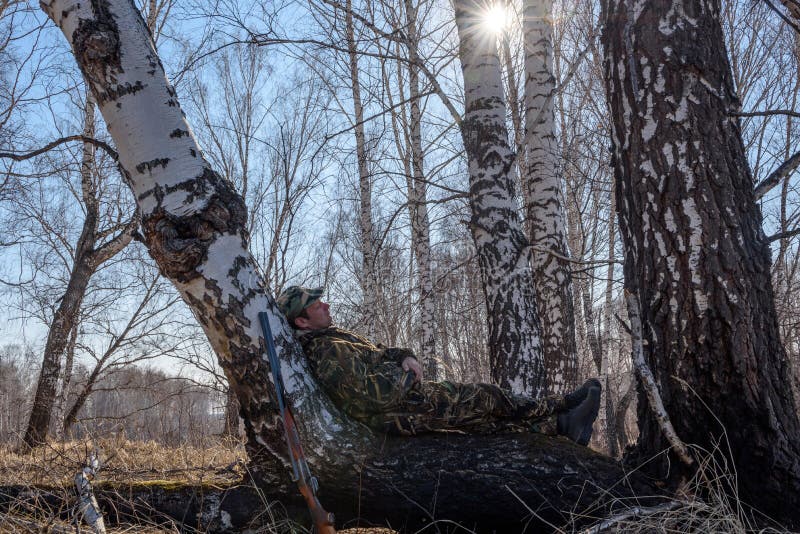 The Hunter is Resting on a Tree Trunk. Stock Image - Image of road ...