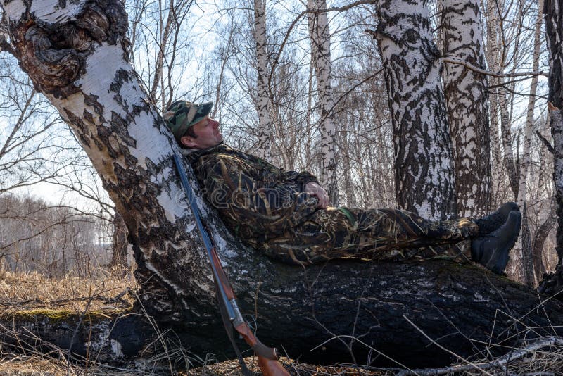 The Hunter is Resting on a Tree Trunk. Stock Photo - Image of forest ...