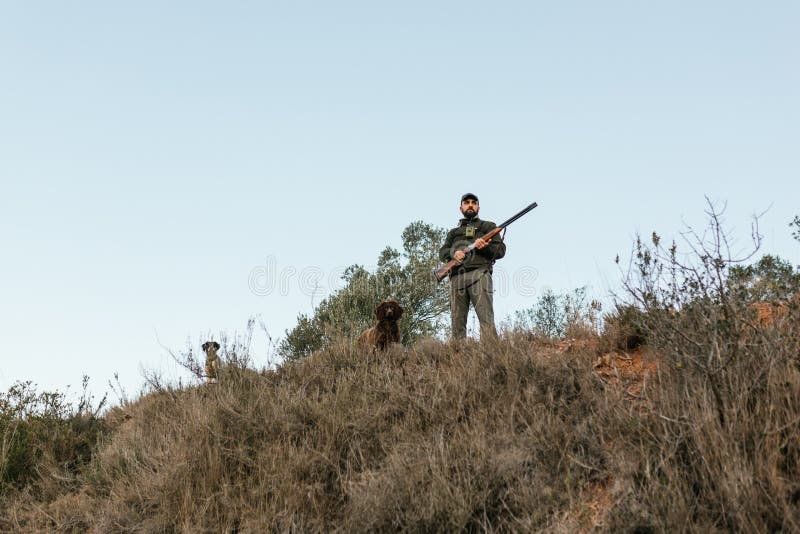 Hunter Holding His Gun Standing Looking for His Prey in Mountains Stock ...