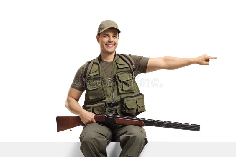 Hunter with a Rifle Sitting on a Panel and Pointing To the Side Stock ...