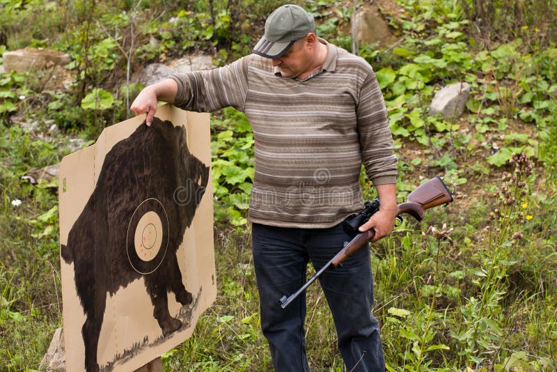 Hunter shooting at target stock photo. Image of grip, rifle - 4794888