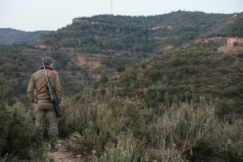 Hunter Standing on Hilltop Looking at Valley Stock Image - Image of ...
