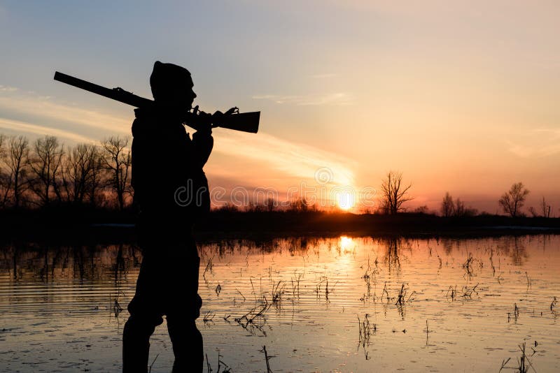 Hunter at sunset. stock photo. Image of duck, reflection - 90697738