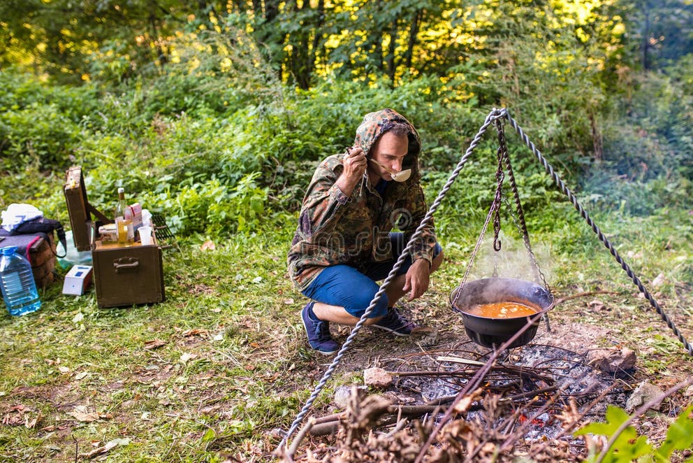 Hunter Tasting Stew Cooked on Bonfire in Forest Stock Image - Image of ...