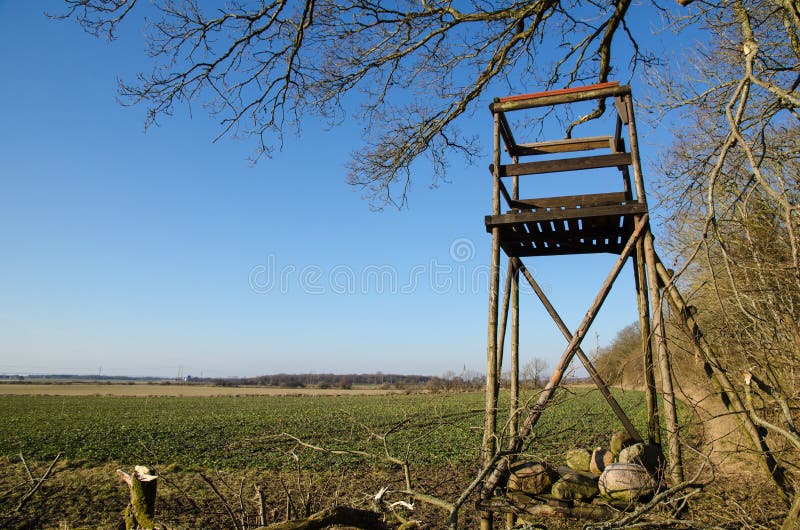 Hunting tower by a field stock image. Image of scene - 51944133