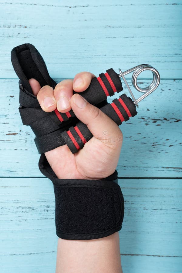 A Hurt Hand Doing Rehabilitation Exercises by Squeezing an a Shape Hand ...