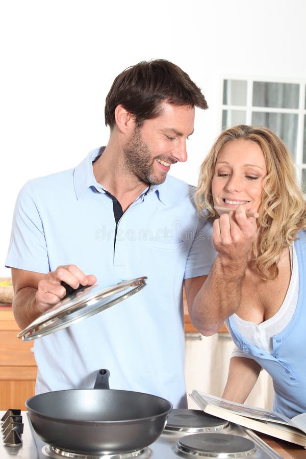 Husband cooking for wife stock image. Image of tasting - 24730487