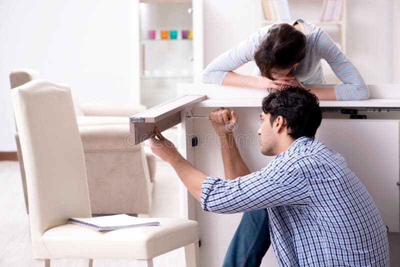 The Husband Repairing Broken Table at Home Stock Photo - Image of ...