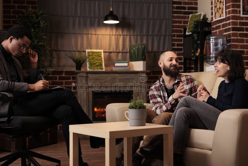 Husband And Wife Attending Couple Therapy Session With Male Therapist