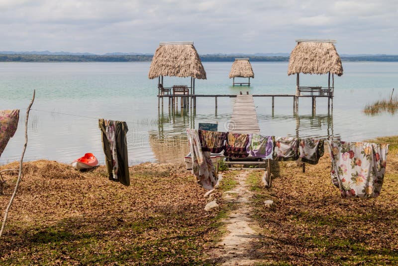 Huts at Peten Itza Lake, Guatema Stock Photo - Image of jetty, pier ...