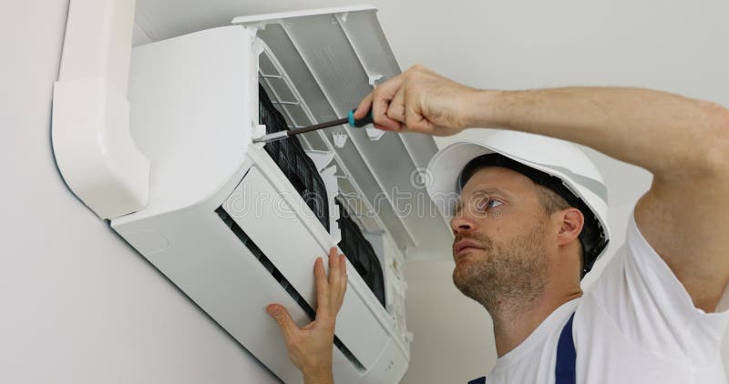 Technician Installing Air Conditioning Unit in Modern Office Stock ...