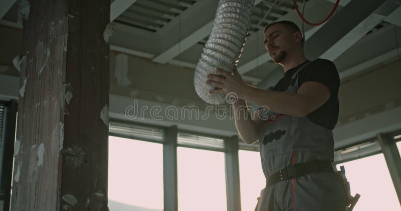HVAC Technician Installing Flexible Duct Work in Commercial Building ...