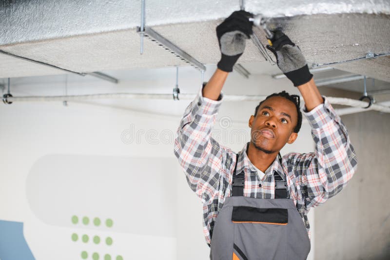 Hvac Technician Installing Ventilation System in Building Ceiling Stock ...