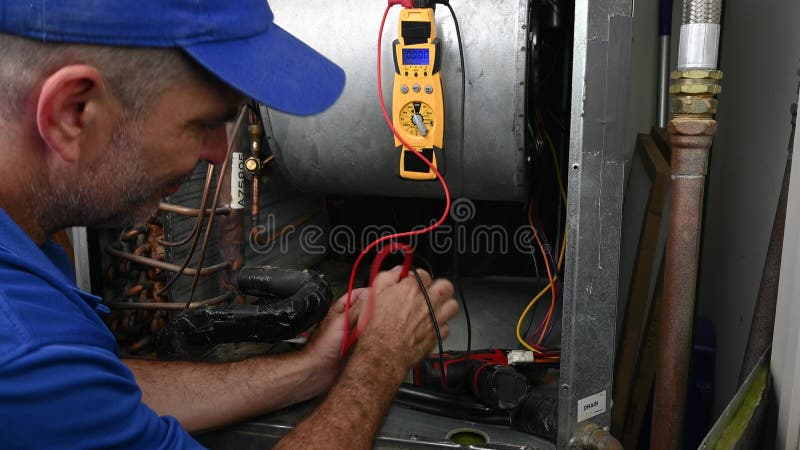 HVAC Technician Cleaning Air Conditioner Filter Using Electric Blower ...