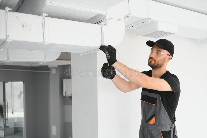 Hvac Technician at Work. Ventilation, Heating System Maintenance and ...