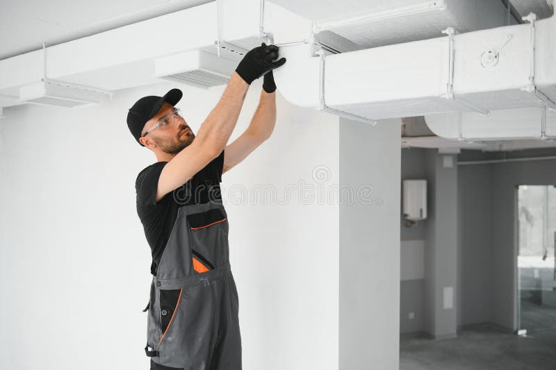 Hvac Technician at Work. Ventilation, Heating System Maintenance and ...