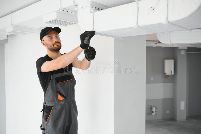 Hvac Technician at Work. Ventilation, Heating System Maintenance and ...