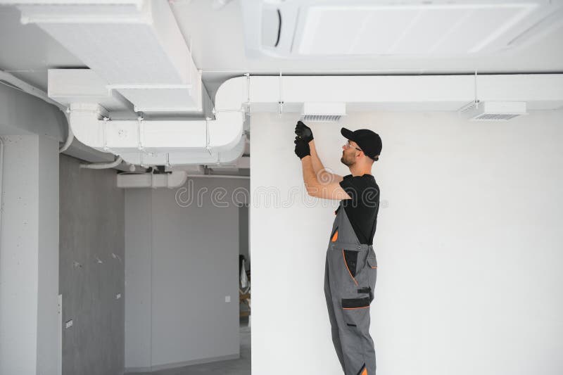 Hvac Technician at Work. Ventilation, Heating System Maintenance and ...