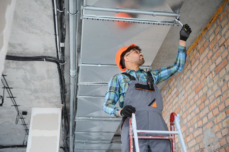Hvac Technician Installing Ventilation System on Construction Site ...