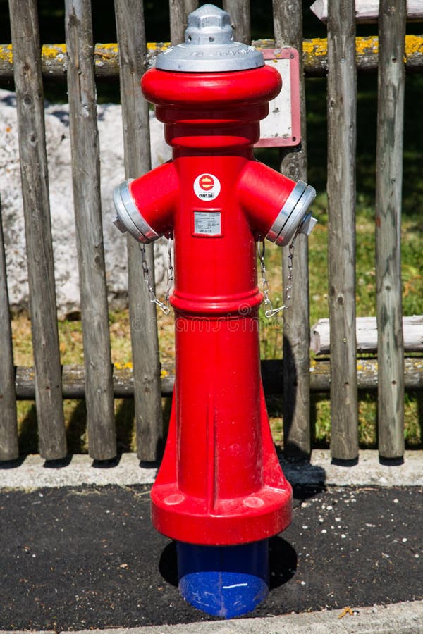 Hydrant, Red Hydrant in Front of Garden Fence Editorial Photo - Image ...