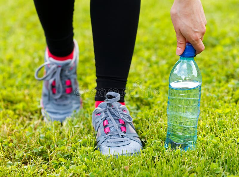 Hydration during workout stock photo. Image of grass - 30894544