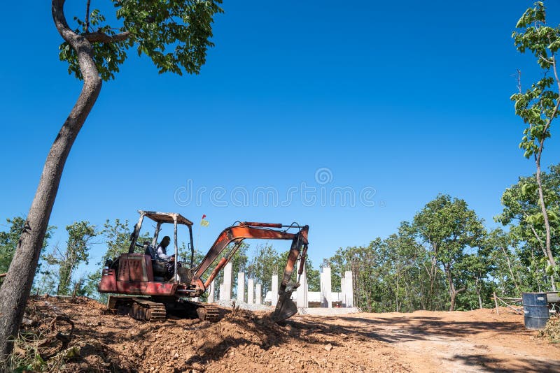 Hydraulic Excavator is Digging Soil at a Construction Site, Surrounded ...